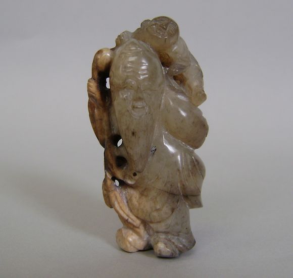 Bonhams : A mottled grey jade (or other stone) carving of Shoulao with ...