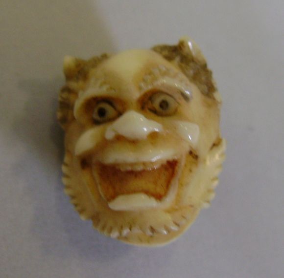 Bonhams : Two ivory ojime: one of two masks; the other of a seated hare