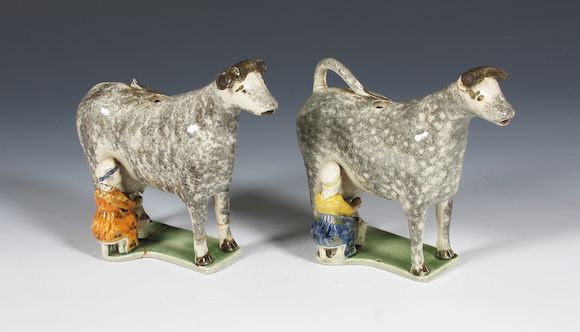 Bonhams : A pair of Pratt Ware cow creamers Early 19th Century.
