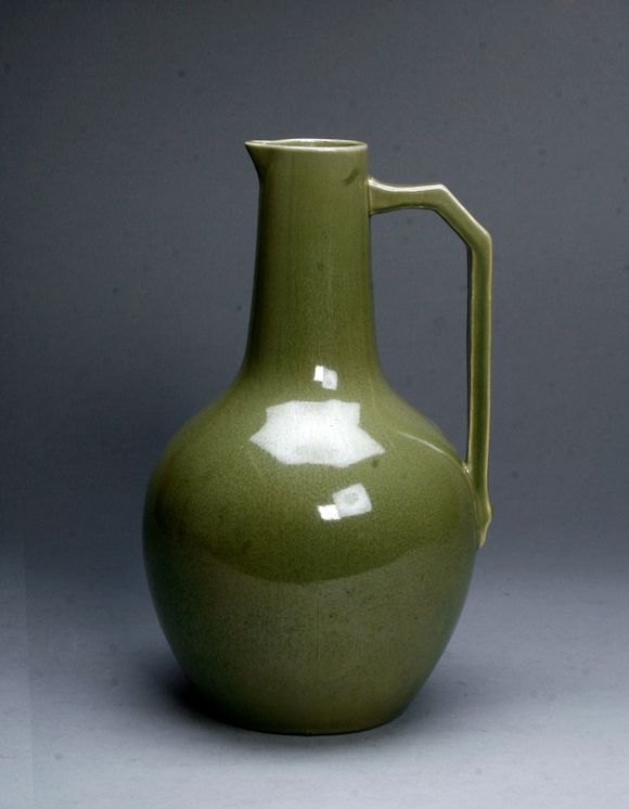 Bonhams : A green pottery pitcher after a design by Christopher Dresser,