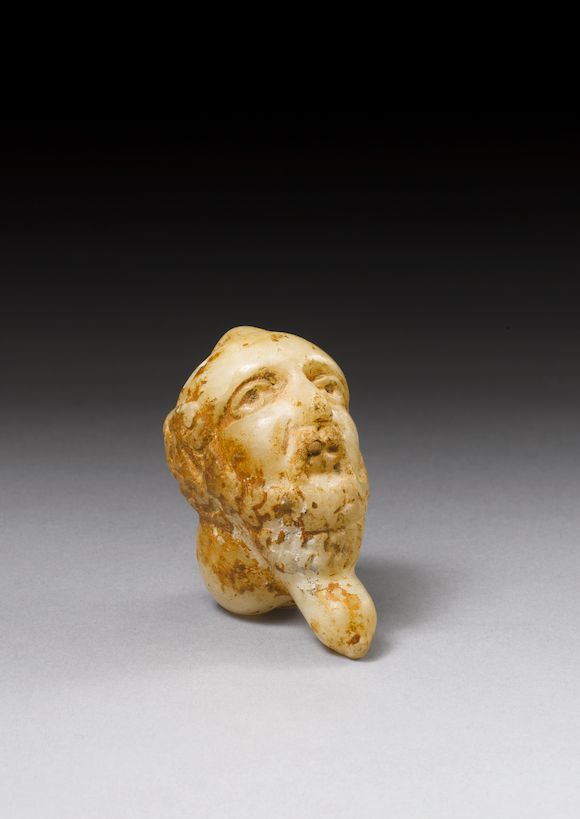 Bonhams : A Romano-British marble phallic male head amulet