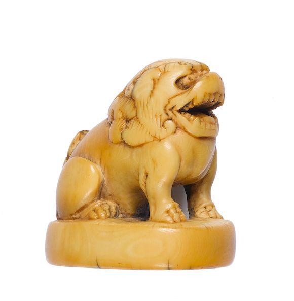 Bonhams : An ivory netsuke of a Karashishi on an oval base decorated ...