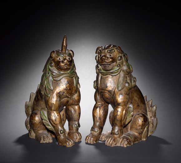 Bonhams : A pair of carved wood, seated mythological animals ...
