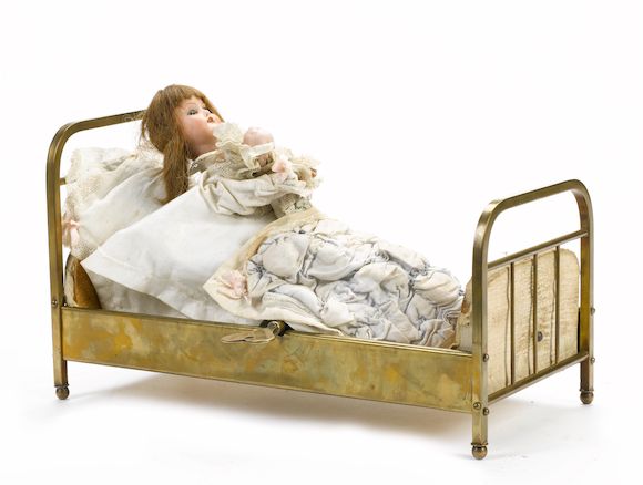 Bonhams : Automaton of doll in bed holding her baby, German circa 1910