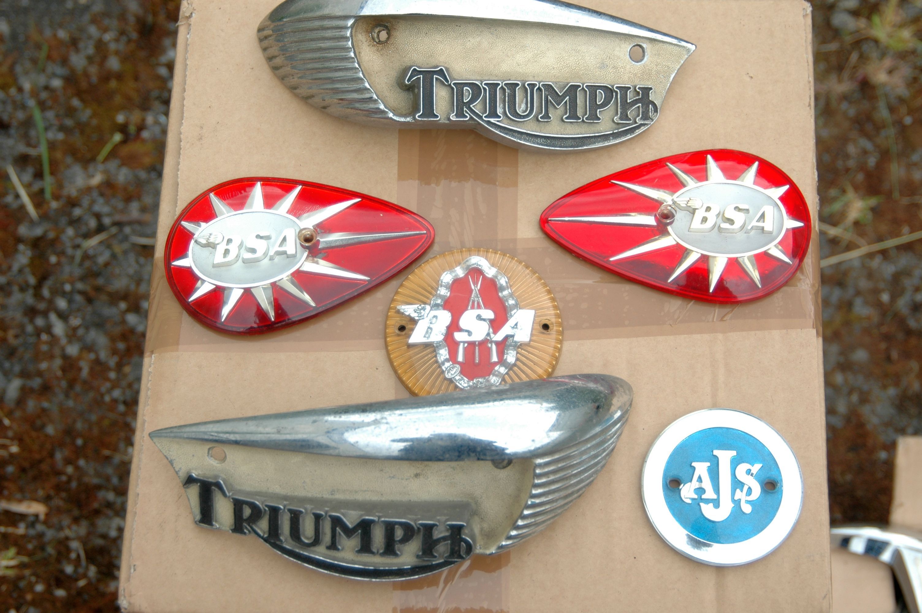 Bonhams Cars : Two pairs of metal Triumph tank badges,