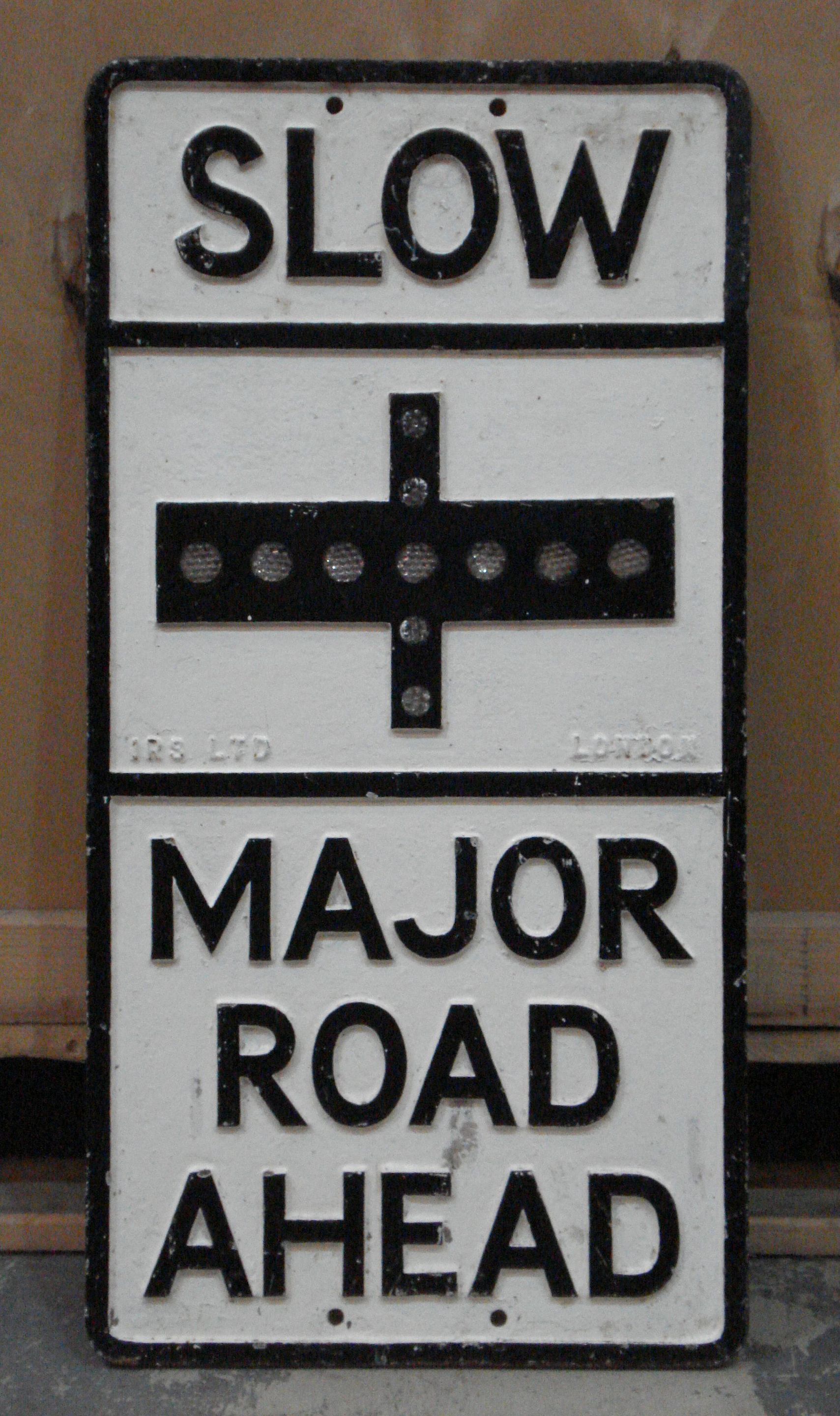 Bonhams Cars : A 'Slow - Major Road Ahead' cast iron road sign,