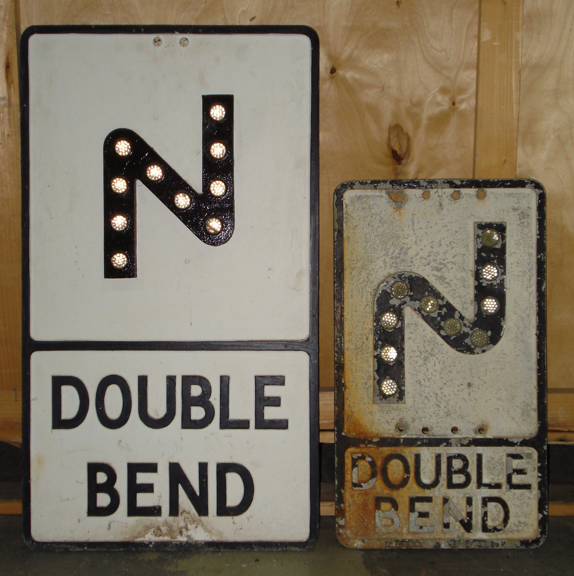Bonhams Cars : Two 'Double Bend' cast alloy road signs,