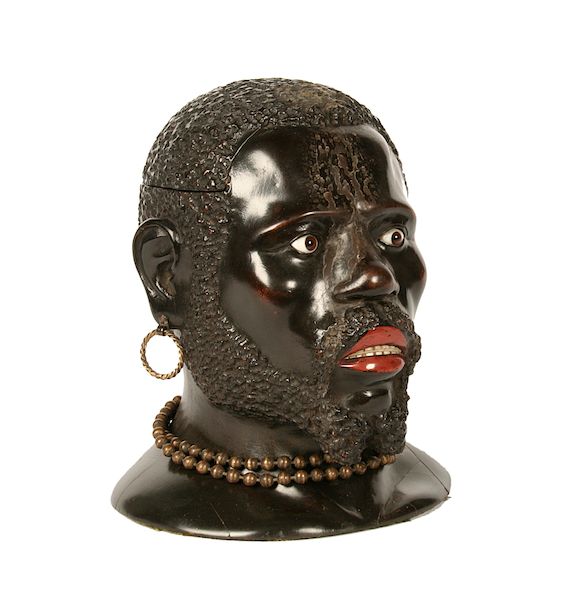 Bonhams : A carved and ebonised tobacco jar modelled as a blackamoor's head