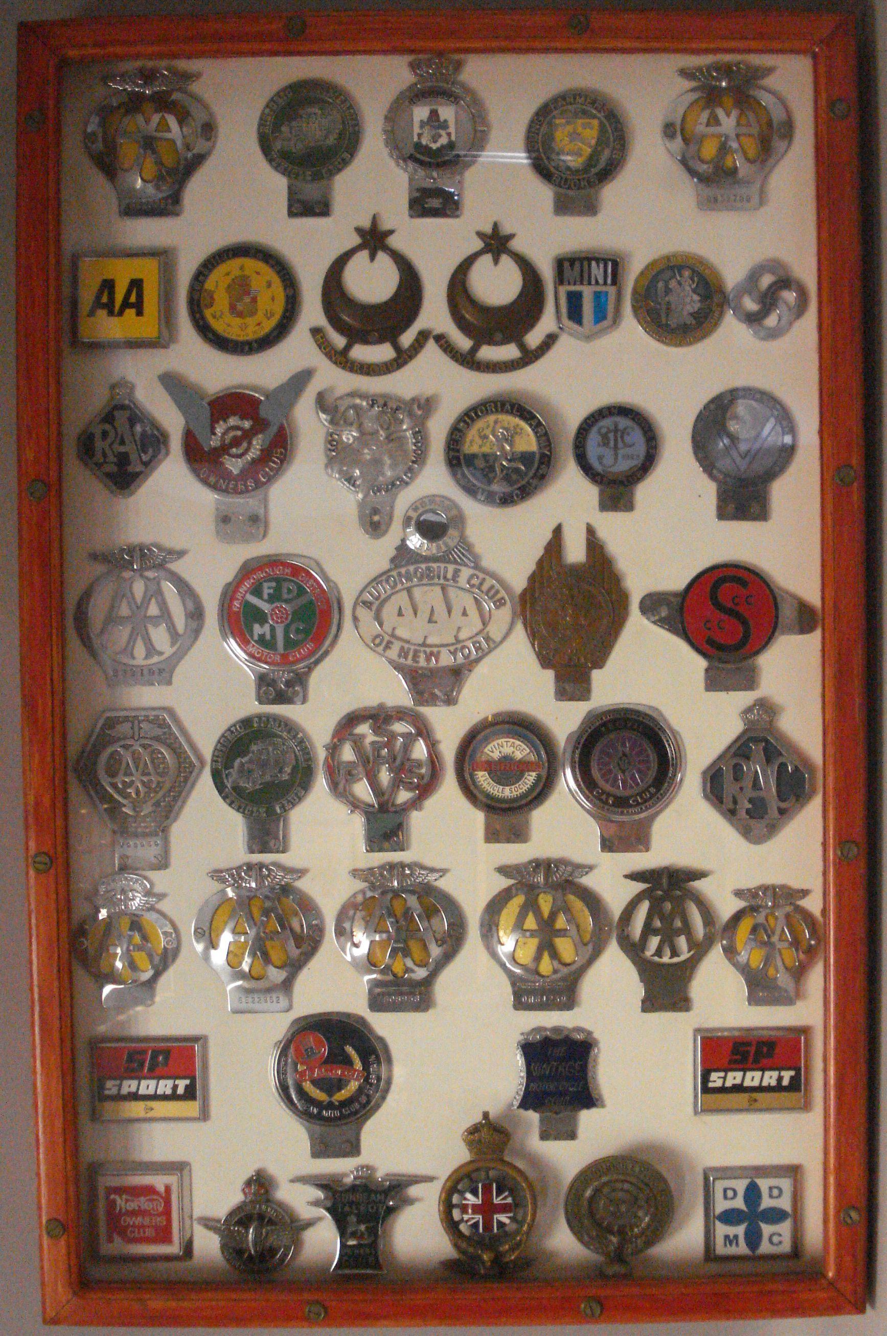 Bonhams Cars : A framed and glazed display of forty-five motoring badges,