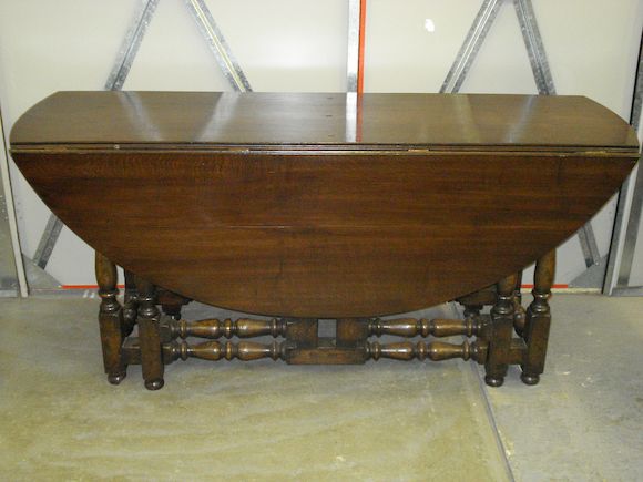 Bonhams : A 17th Century style oak oval gate-leg table,