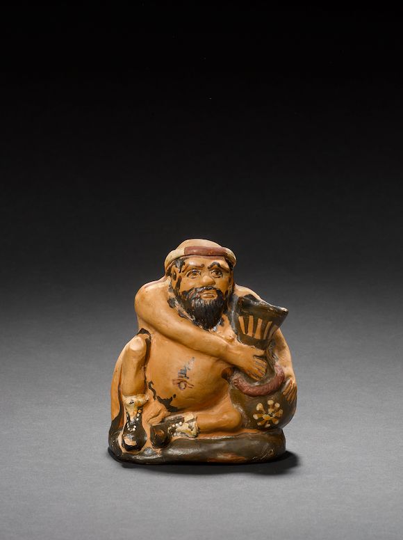 Bonhams : A Faliscan 'plastic' vase in the form of Silenus