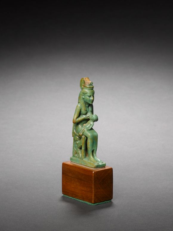 Bonhams : An Egyptian green glazed composition amulet of Isis and Horus