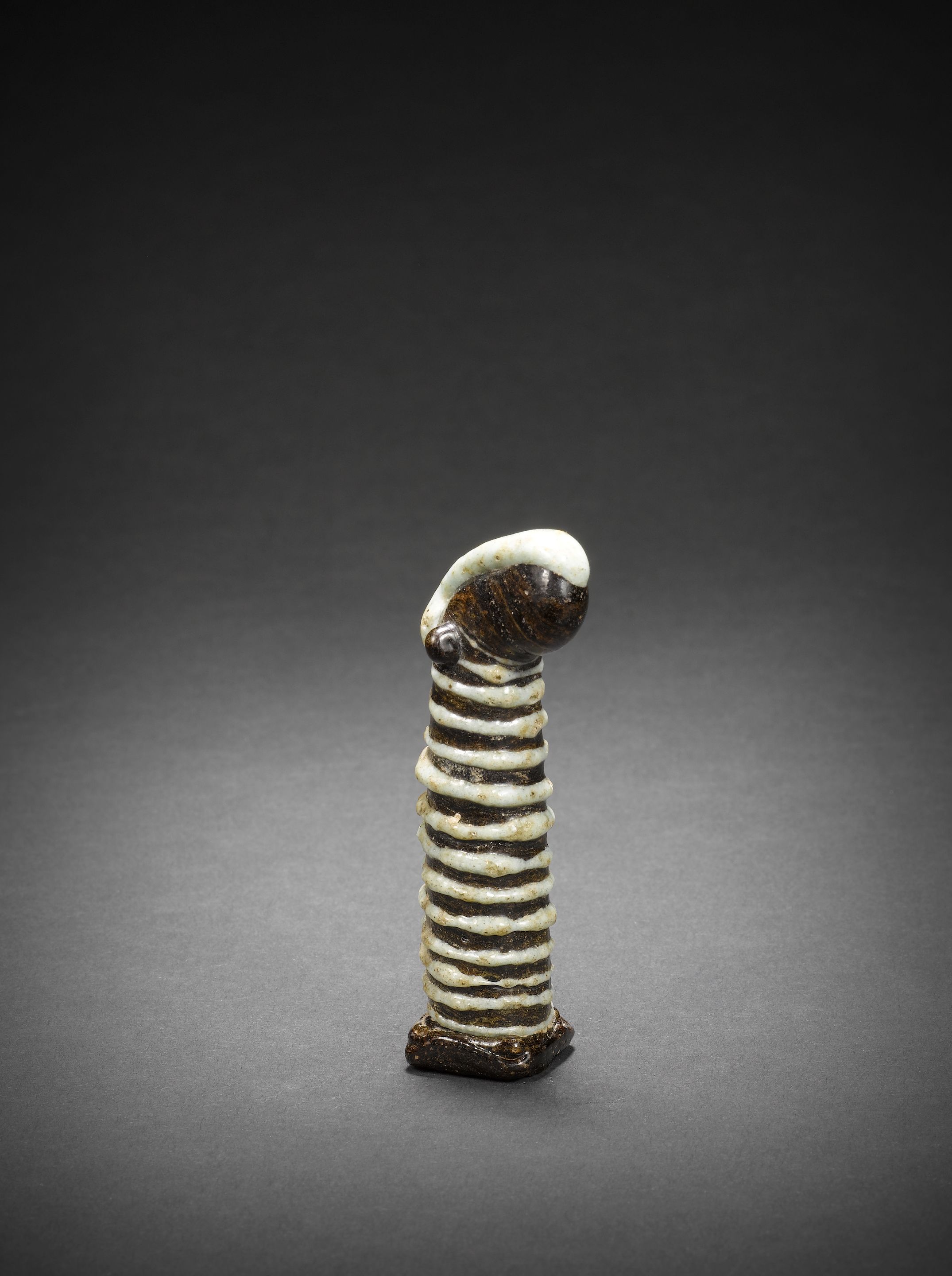 Bonhams : An Achaemenid rod-formed ram's head handle