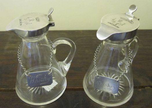 Bonhams : A pair of cut glass whiskey tots with silver hinged covers ...