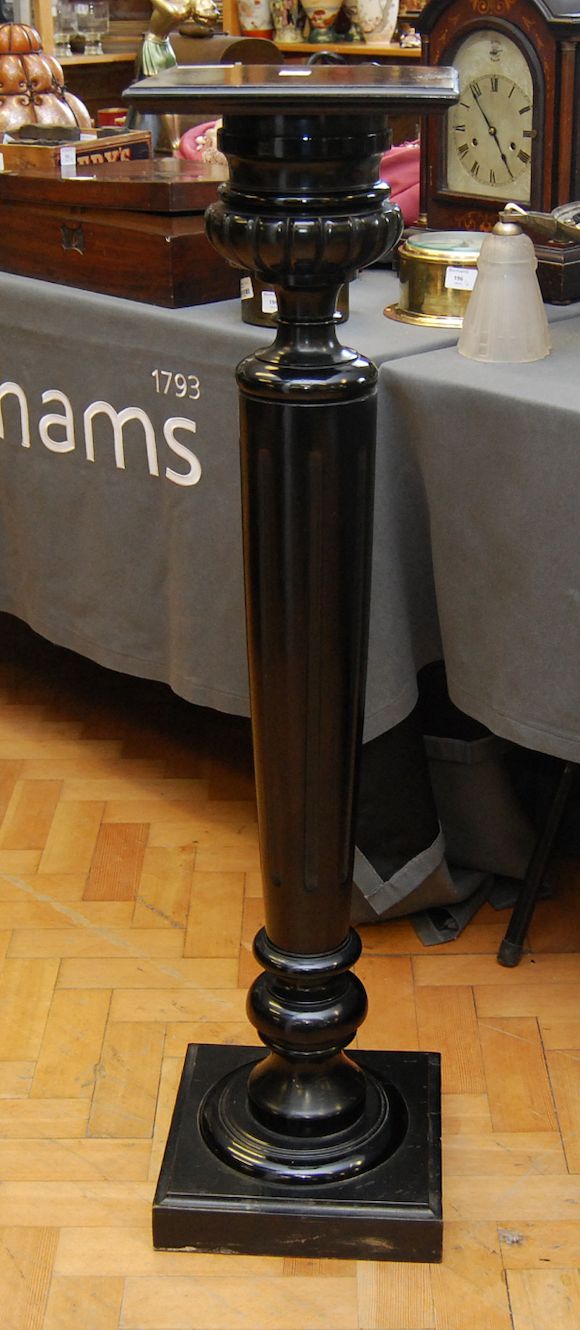 Bonhams : A black-painted wooden torchere