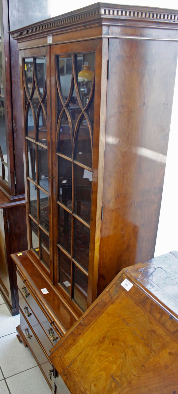 Bonhams : A reproduction yew wood display cabinet on chest