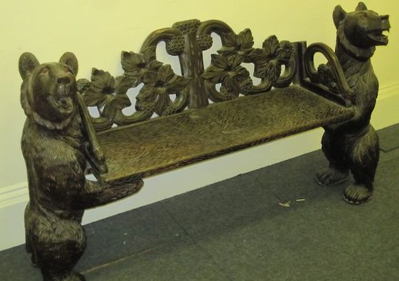 Bonhams : A carved Black Forest bench seat, modelled as two standing ...