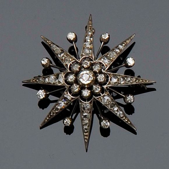 Bonhams : A diamond set eight rayed star brooch/pendant