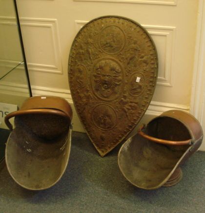 Bonhams : A Victorian copy cast iron shield, and two copper coal scuttles.