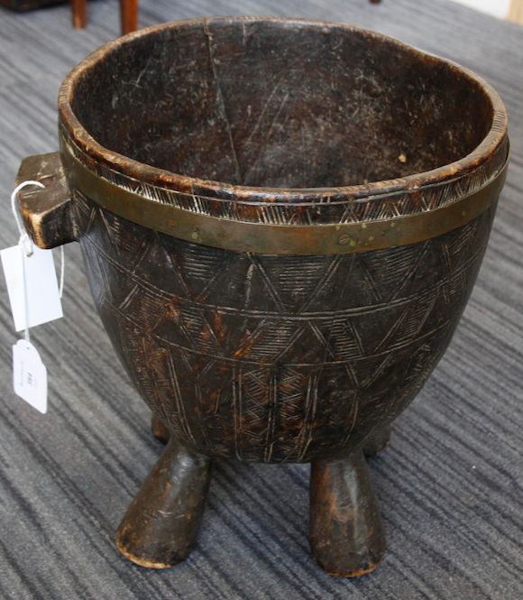 Bonhams : A 20th century carved African vessel 34cm high.
