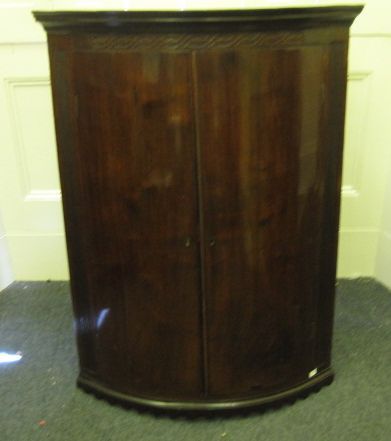 Bonhams : A George III mahogany bowfront corner cabinet, with moulded ...