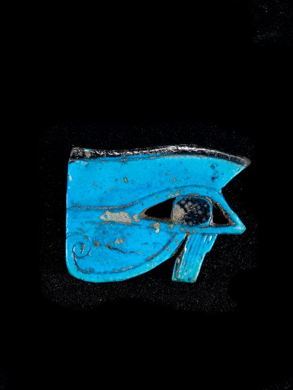 Bonhams : An Egyptian bright blue glazed composition udjat eye amulet