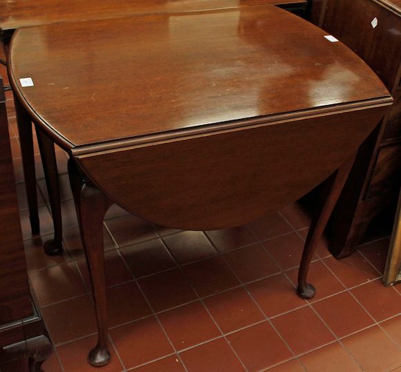 Bonhams : A mahogany oval drop flap table