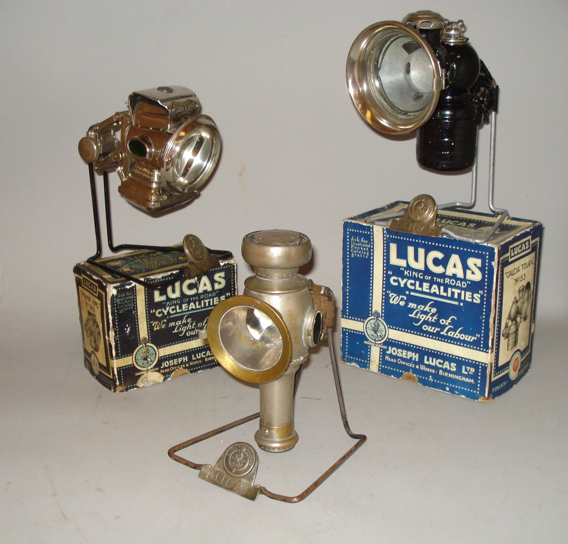 Bonhams Cars : Three Lucas cycle lamps mounted on Lucas shop display ...
