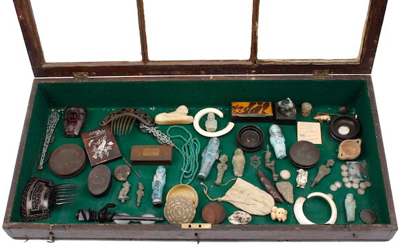 Bonhams : An old flat showcase with sloping glazed top,