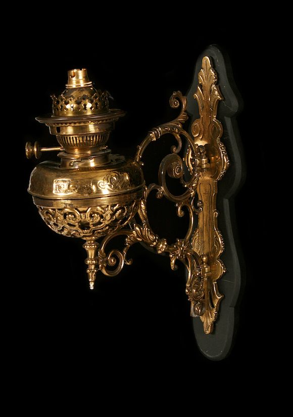 Bonhams : A Victorian brass wall light,originally a gas lamp,
