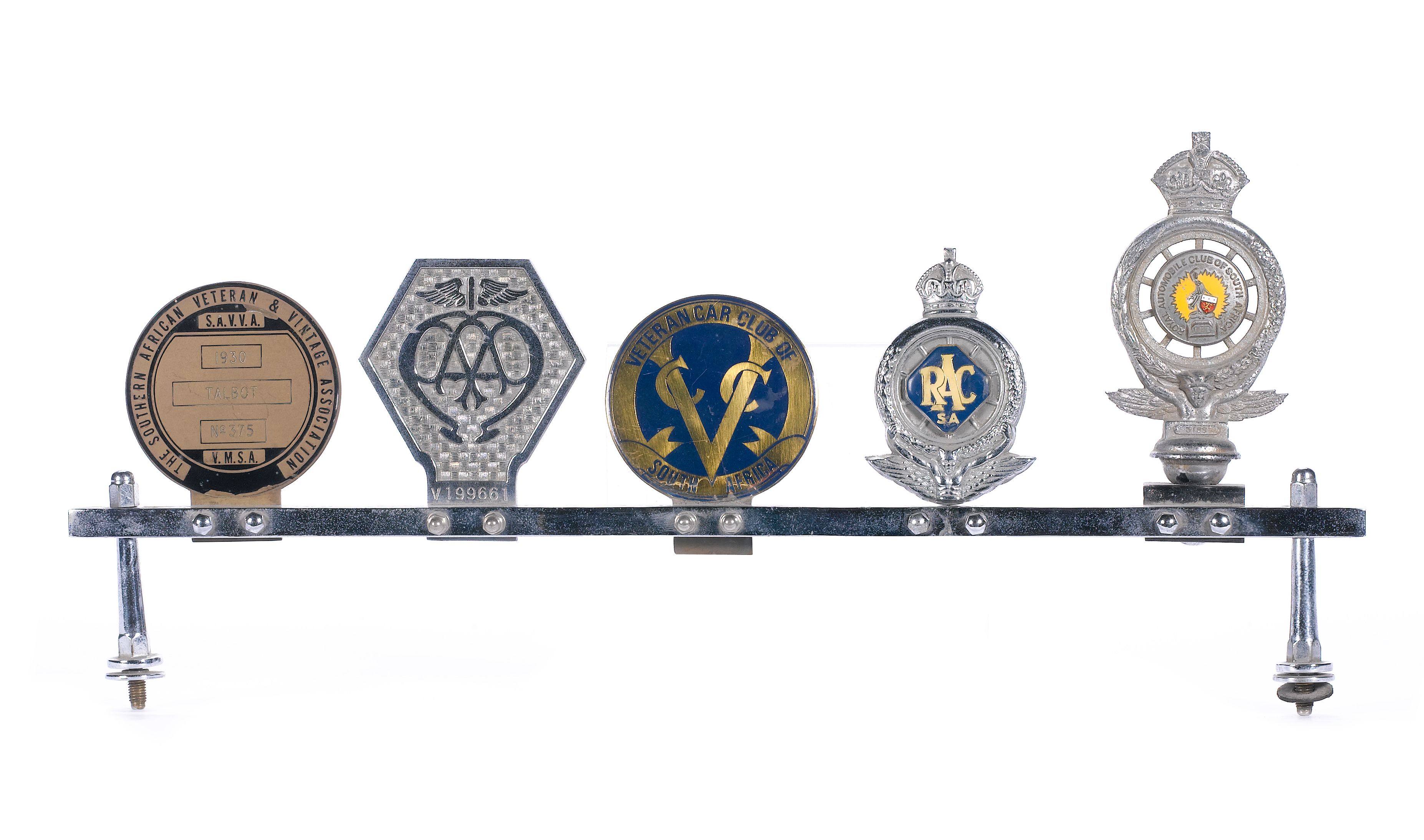 Bonhams Cars : A badge bar fitted with South African motoring badges,