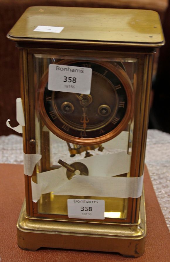 Bonhams : A brass cased four glass clock, the gilt dial with black ...