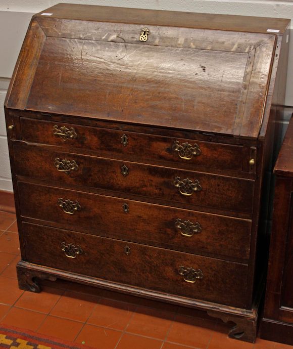 Bonhams : A late George III oak bureau,fitted below the fall front with ...