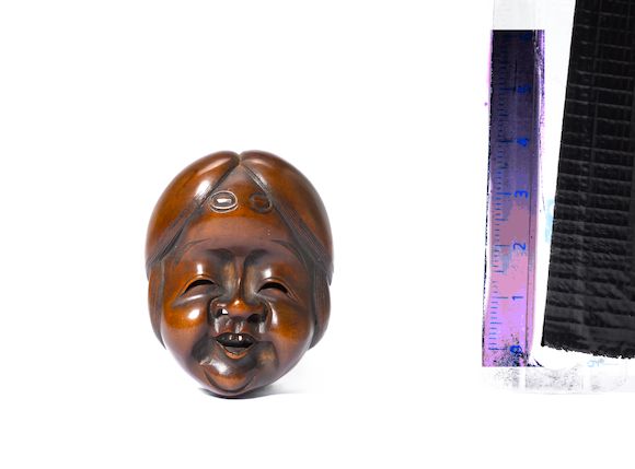 Bonhams : A wood mask netsuke of Okame By Shuzan, Edo, 19th century