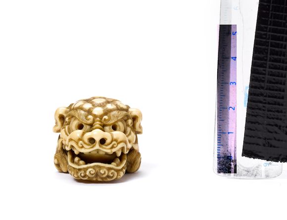 Bonhams : An ivory netsuke of a shishi head Attributed to Tomotada ...