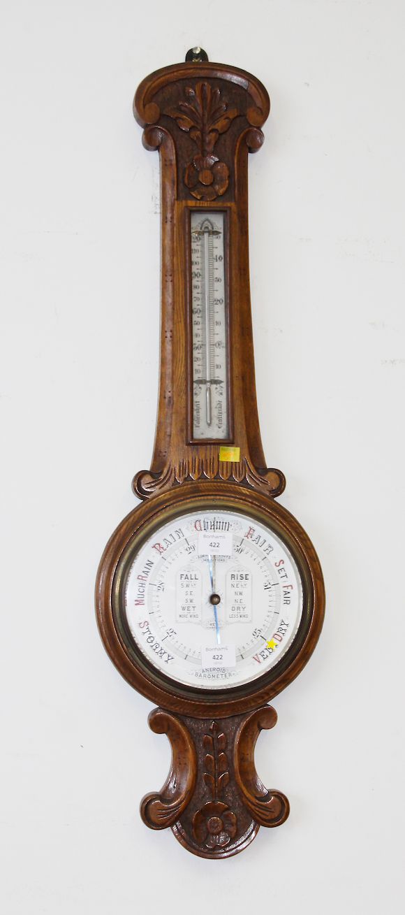 Bonhams : An oak cased aneroid barometer and thermometer,