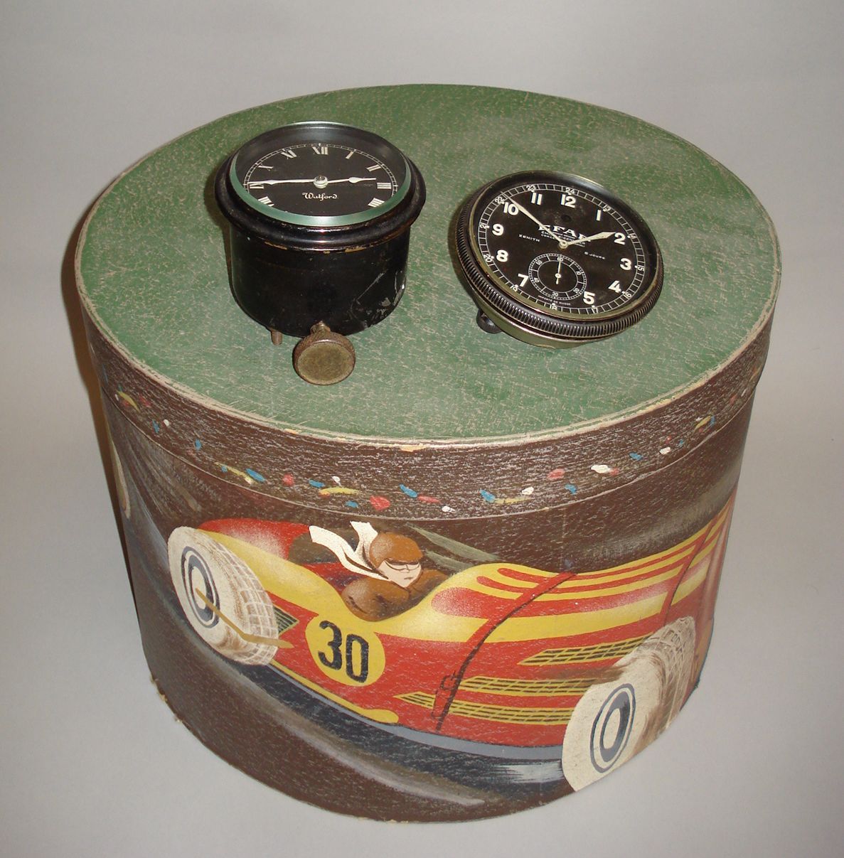 Bonhams Cars : Two car clocks and a hat box,