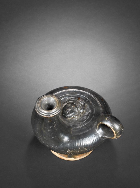 Bonhams : A large Calene ware black glazed guttus