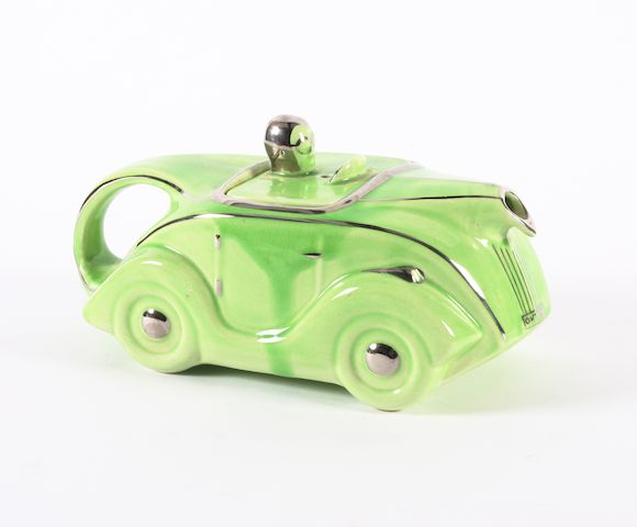 Bonhams : An Art Deco style earthenware novelty racing car teapot and cover
