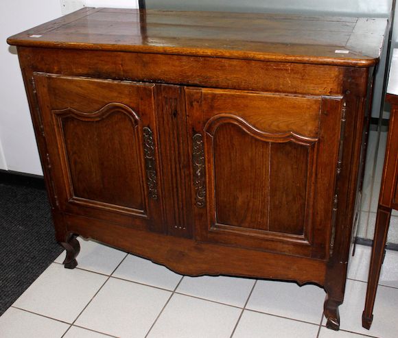 Bonhams : French provincial low armoire on cabriole legs