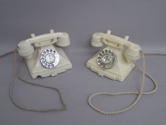 Bonhams : Two 200-series ivory bakelite telephones: impressed marks: 164 55 and 57
