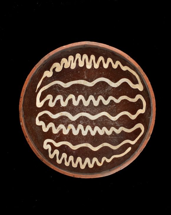 Bonhams : A Staffordshire slipware dish, 18th century