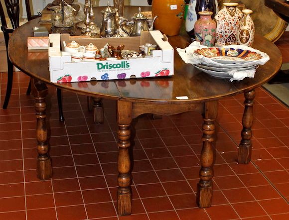 Bonhams : A large Irish wake style reproduction oak gateleg table