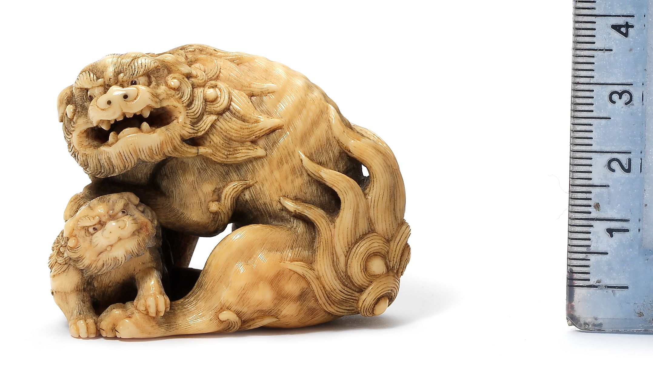 Bonhams : An ivory netsuke of a shishi and cub Attributed to Tomotada ...