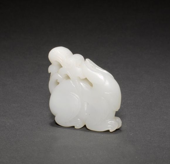 Bonhams : A small pale celadon jade carved as a rabbit looking over his ...