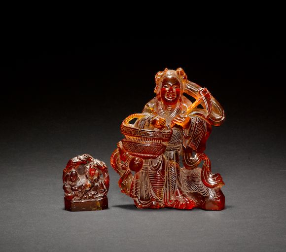 Bonhams : Two pressed amber sculptures, including: one designed as two ...