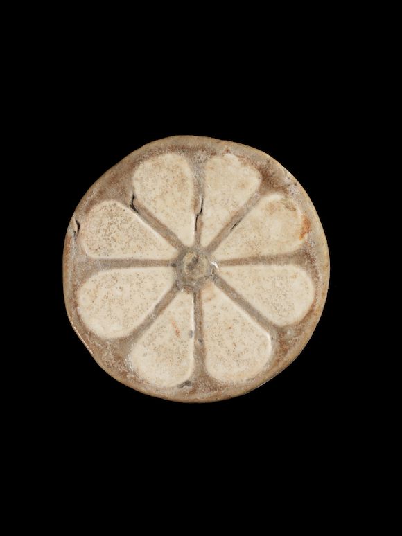 Bonhams : An Egyptian glazed composition rosette inlay