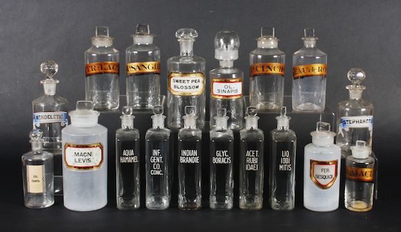 Bonhams : A quantity of various clear glass drug rounds and other bottles