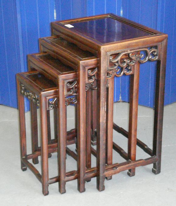 Bonhams : A set of four Chinese rosewood inter fitting tables,