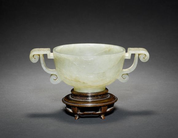 Bonhams : An archaistic jade cup with scrolling handles; decorated with ...